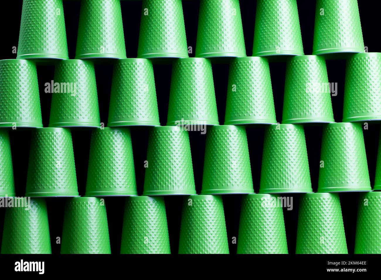 disposable plastic cups of green color, a group of clean new plastic ...