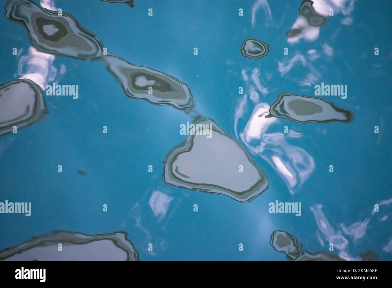 Light and shadows create abstract patterns in blue ocean water Stock ...