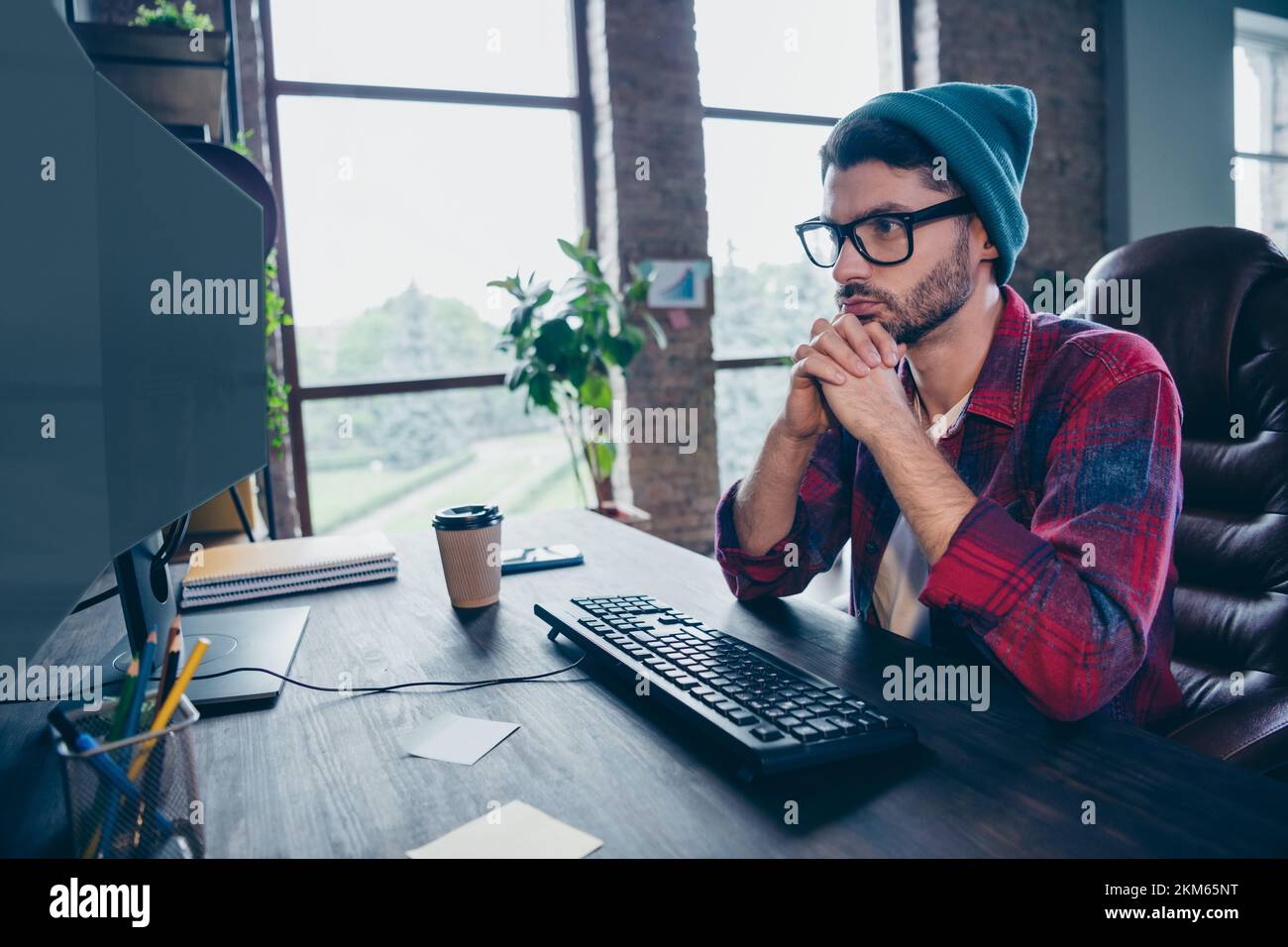 Photo of thoughtful clever freelancer wear hat glasses hands arms chin ...