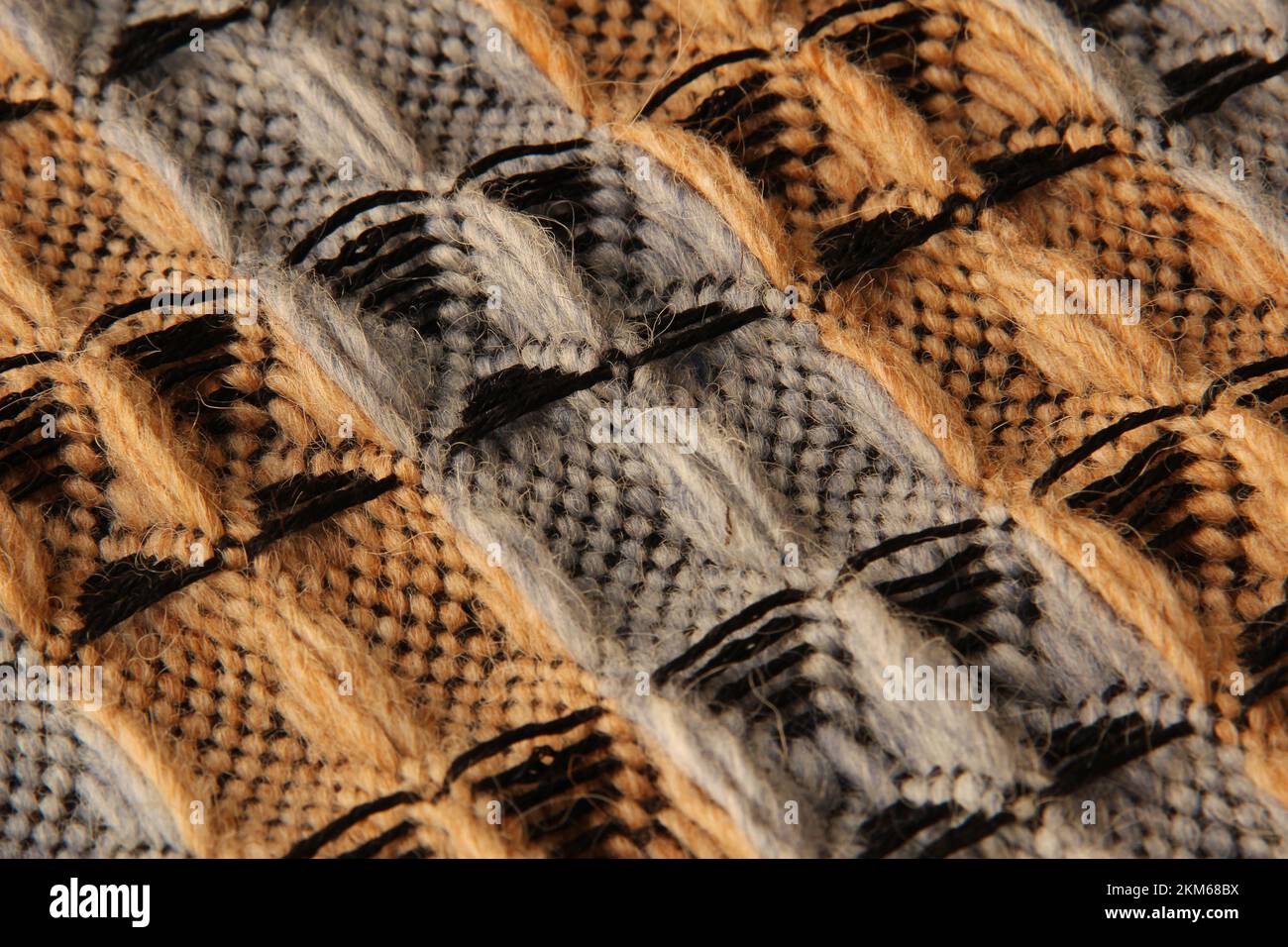 Closeup of threedimensional waffle weave pattern in orange and grey ...