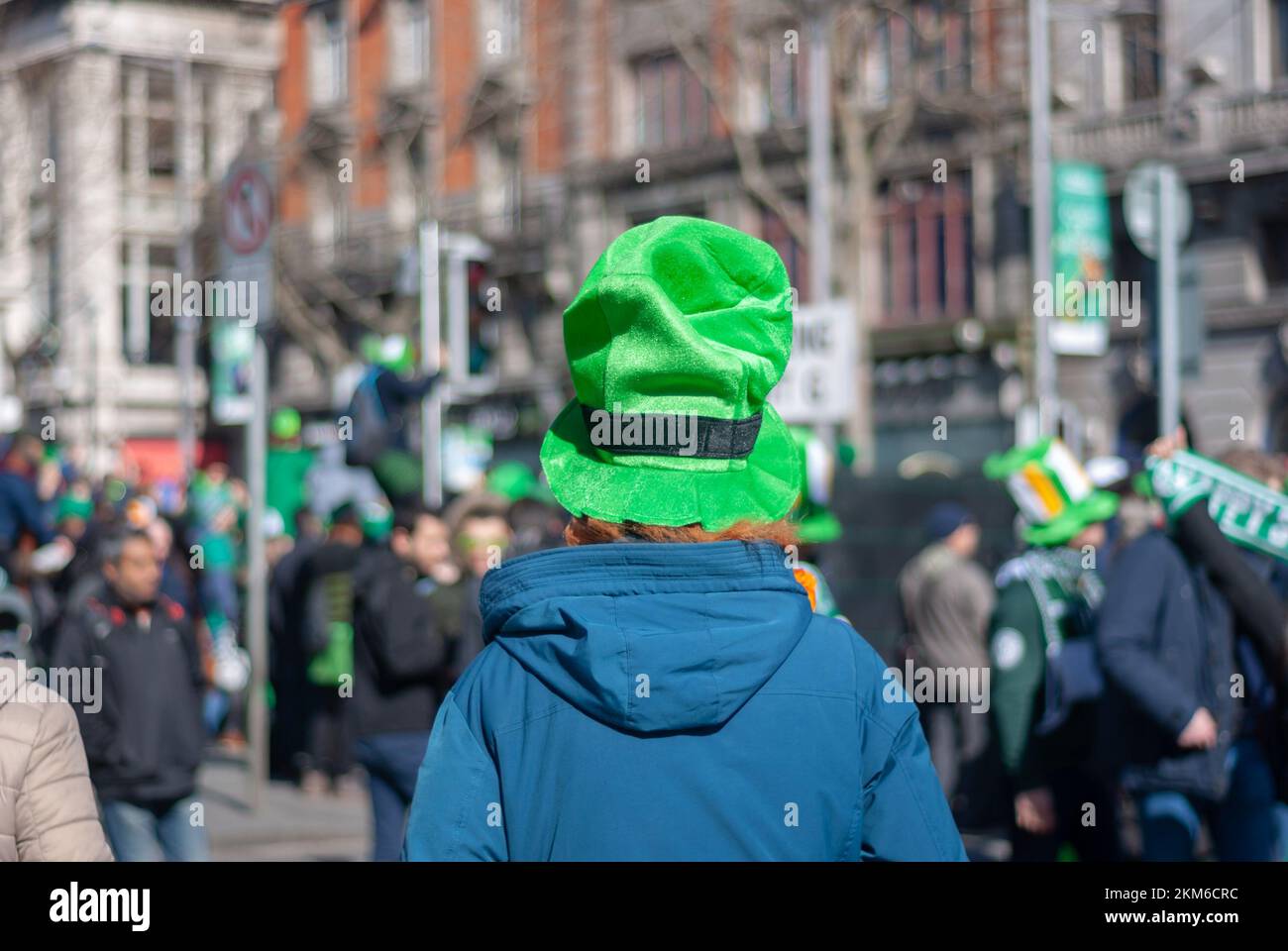 A back view of a person in Dublin city center during a busy Saint ...