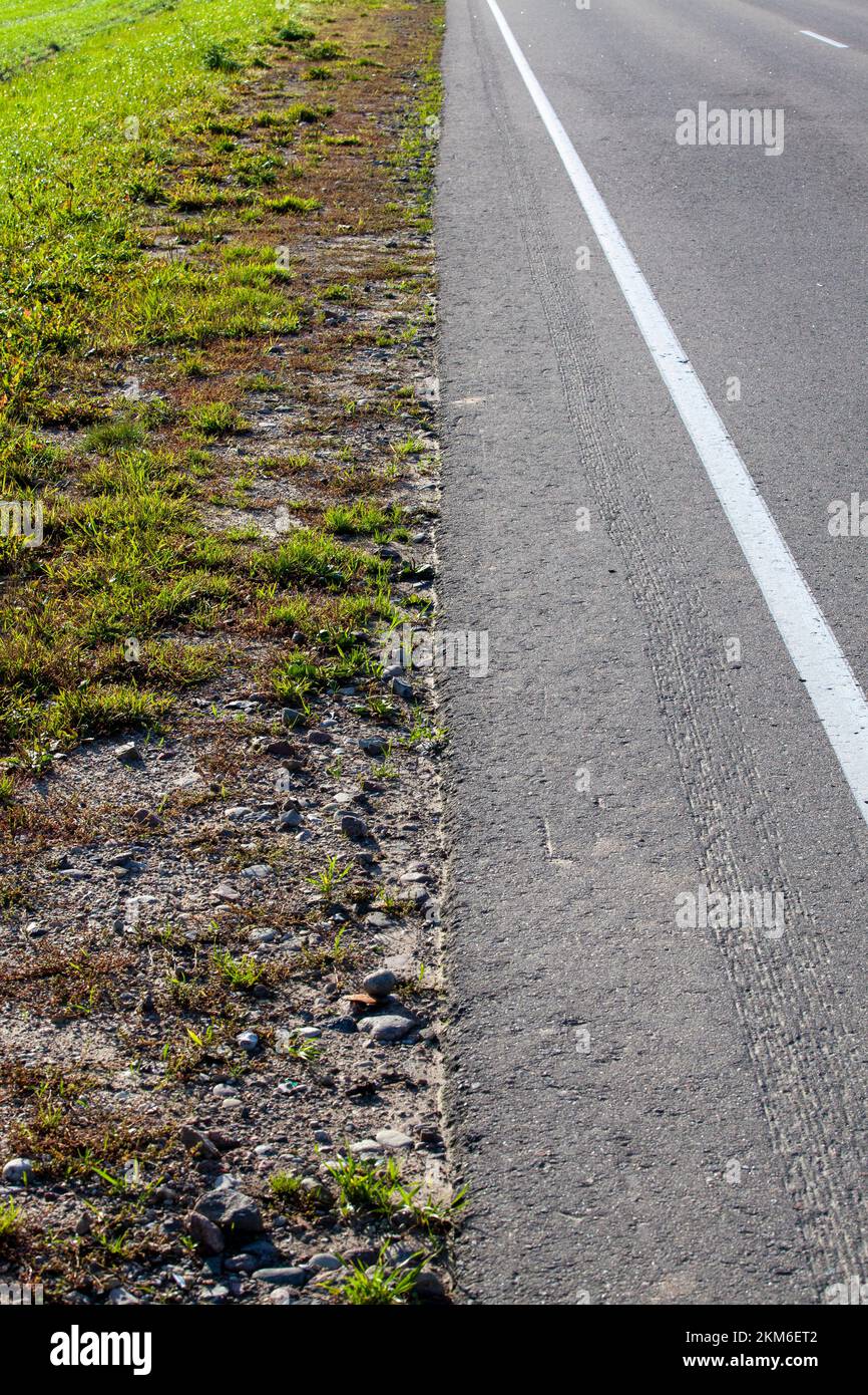 an empty old paved road , road markings on an asphalt highway Stock ...