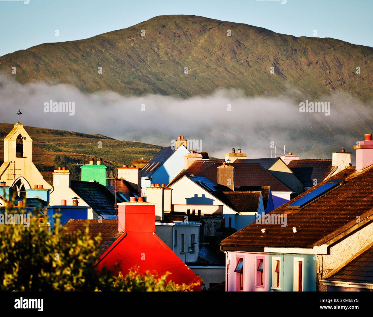 Misty summer dawn with backdrop of Maulin mountain in the colourful ...