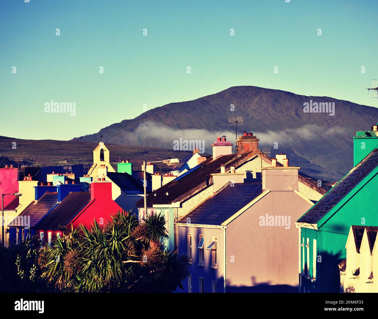 Misty summer dawn with backdrop of Maulin mountain in the colourful ...