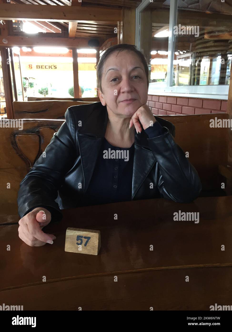 The woman at the table in the cafe Stock Photo - Alamy