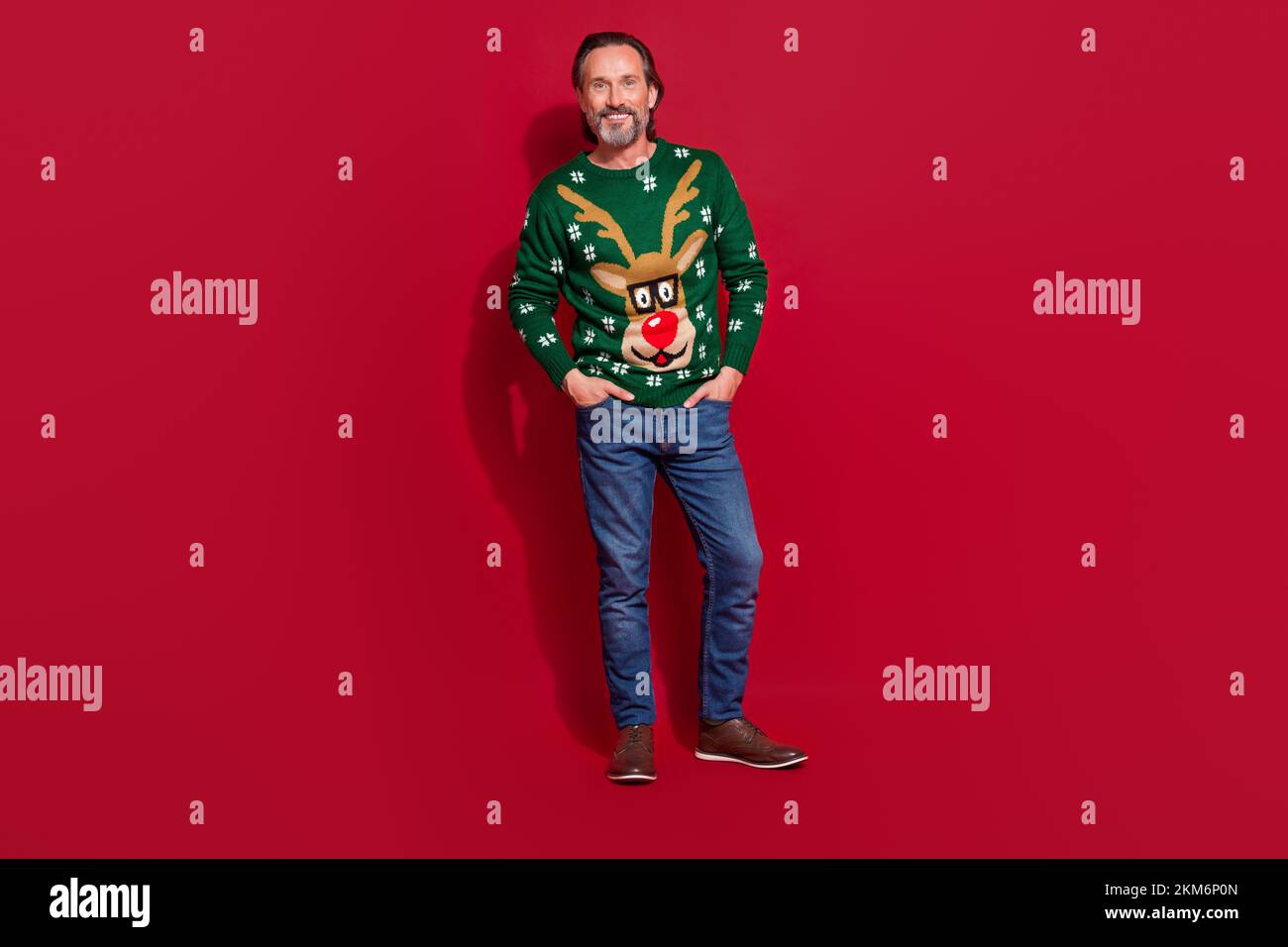 Full length photo of cheerful positive guy dressed xmas green pullover ...