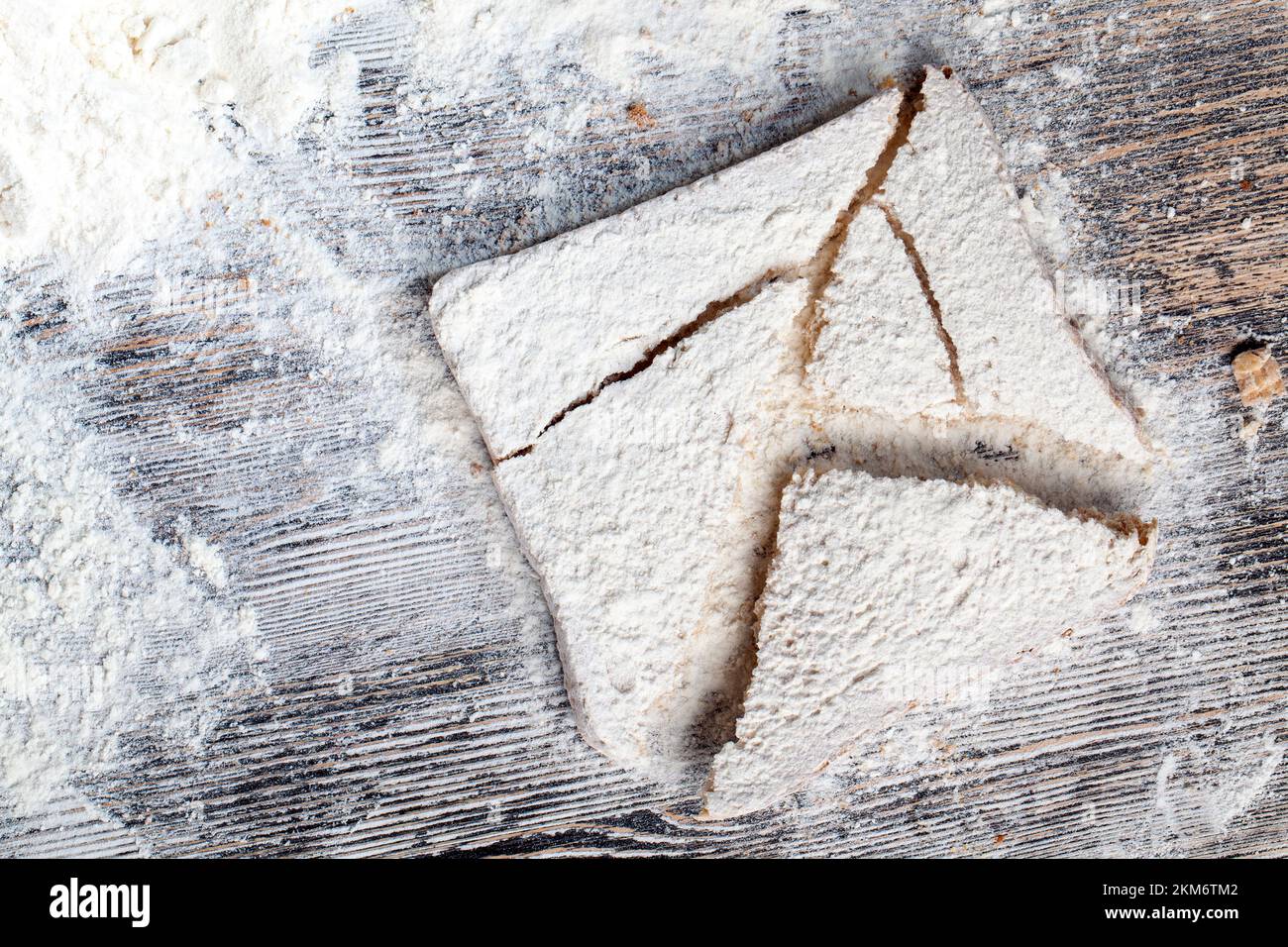 wheat flour bread and wheat flour on a board, thin broken wheat bread ...