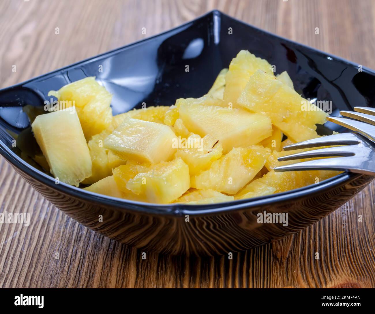 pieces of ripe and juicy pineapple on the table, cut into pieces ripe ...