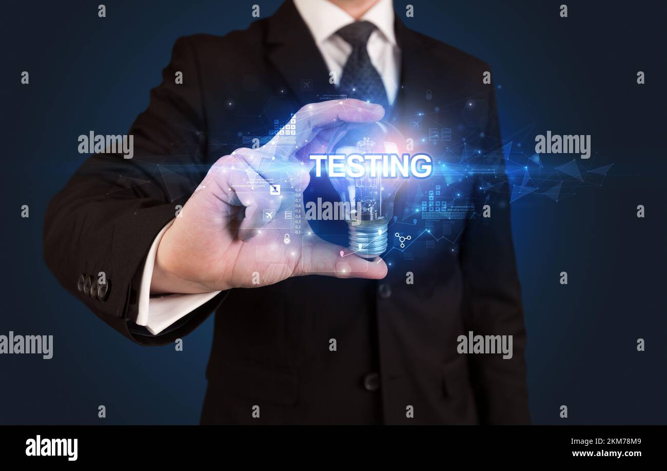 Businessman holding a light bulb Stock Photo - Alamy