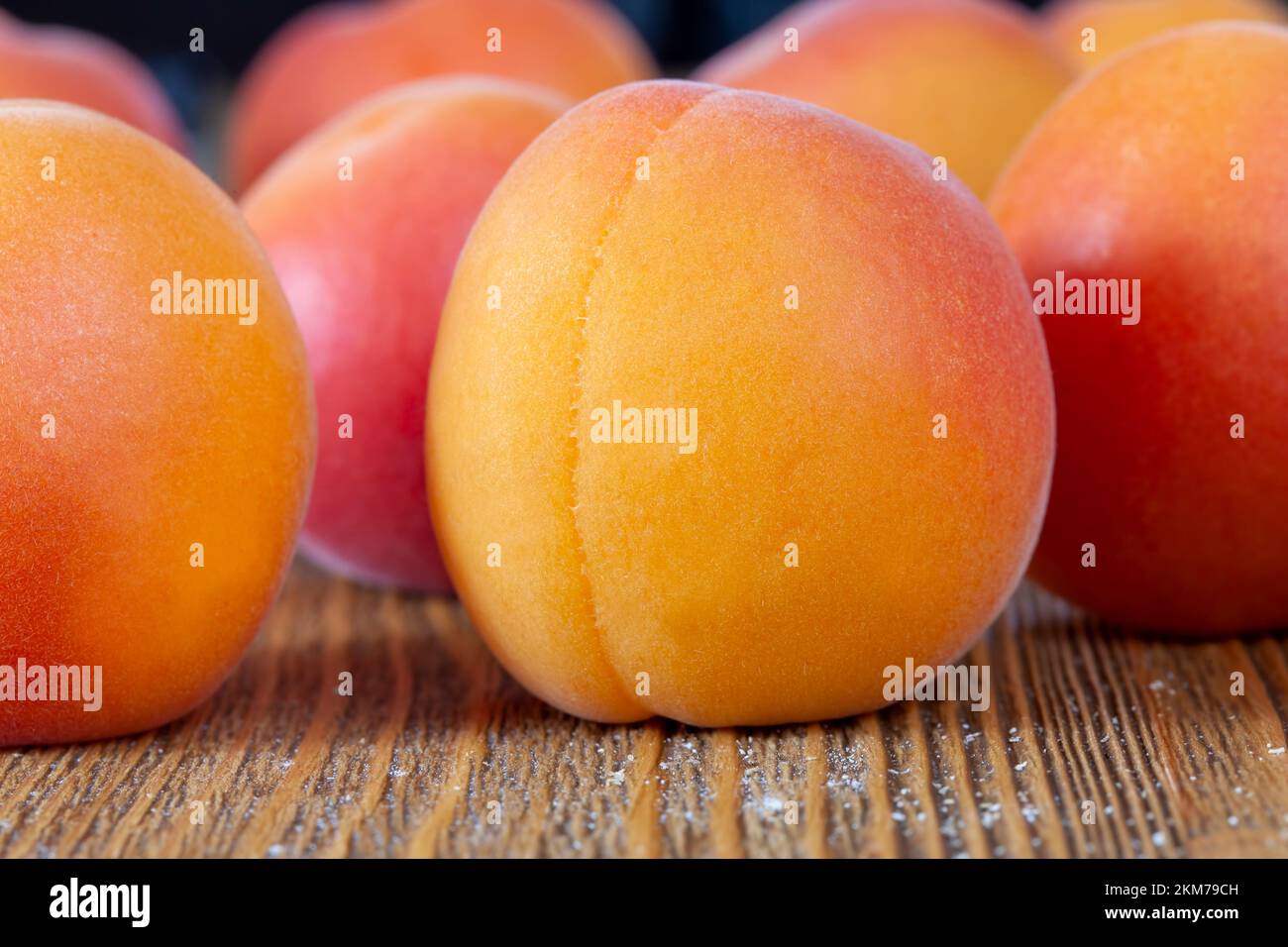 orange sweet apricots on the table in the kitchen, cooking from fruit ...
