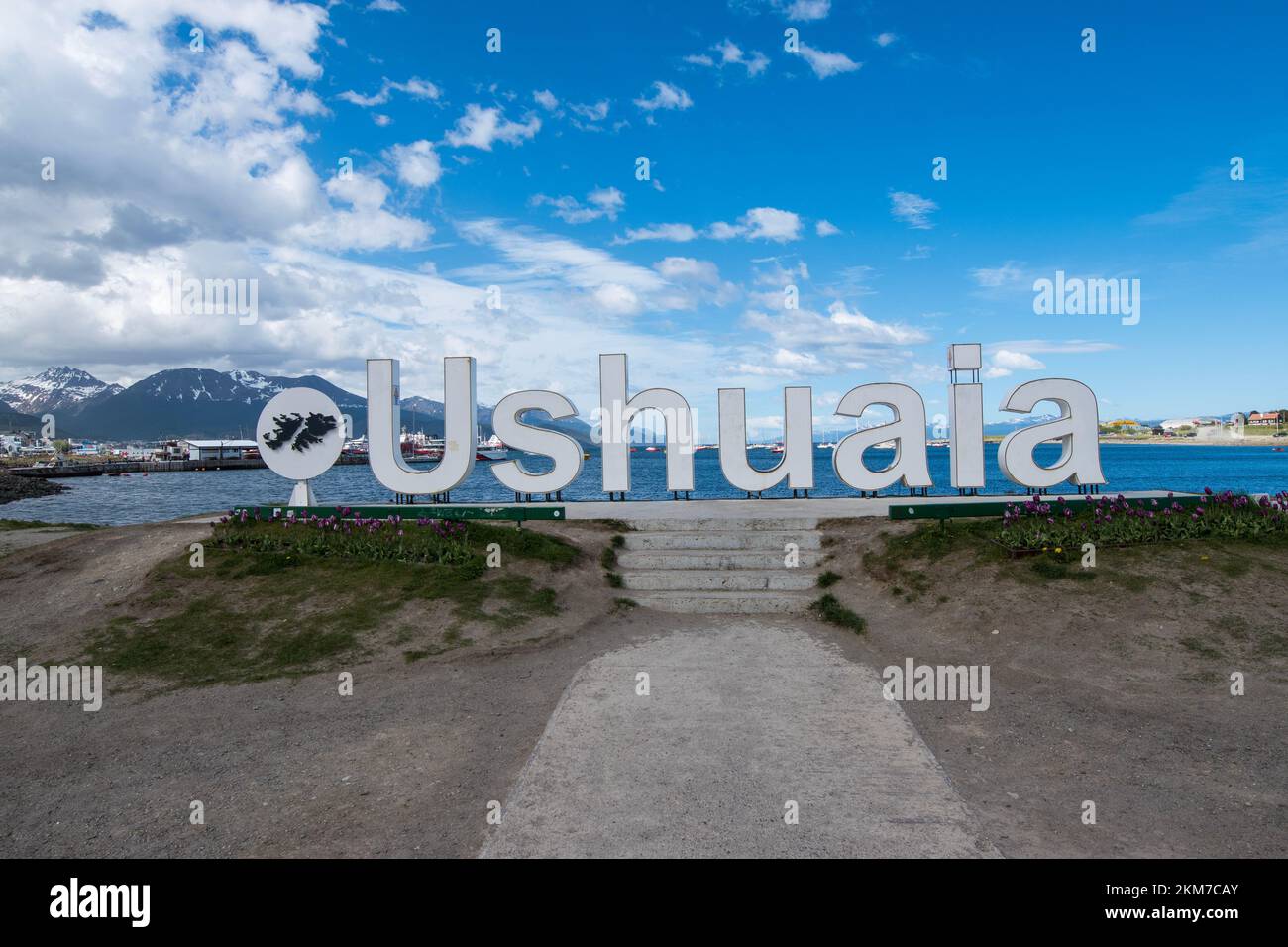 Looking out at the ocean behind the Ushuaia Sign in Argentina Stock ...