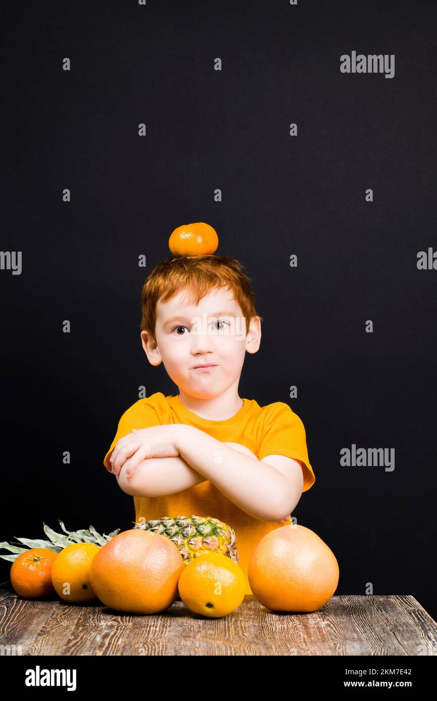 a beautiful red haired boy with citrus fruits from which you can make ...