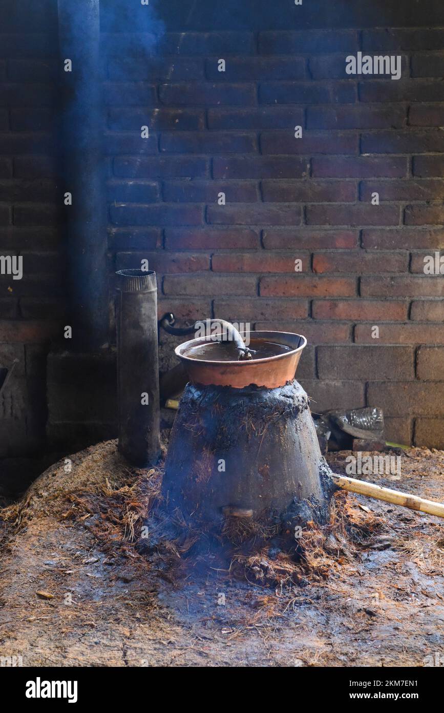 The distillation process of the fermented maguey in a artisanal Mezcal ...