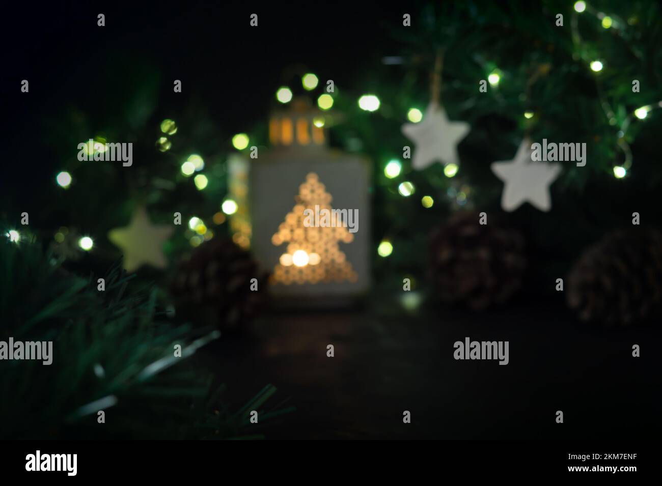 Blurred Christmas background with branches, cones, garland and ...