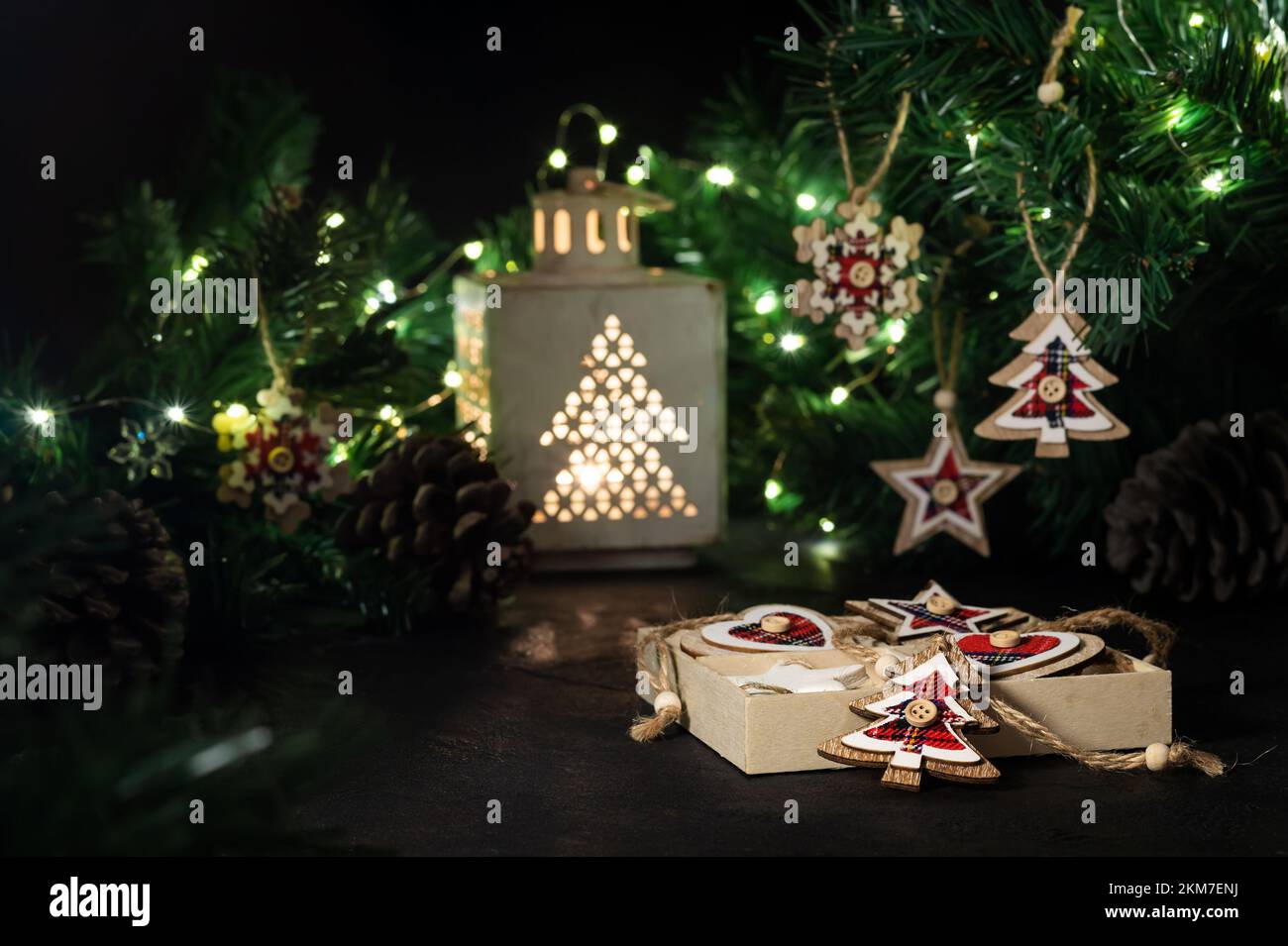 Christmas background with branches, cones, garland and a box with ...