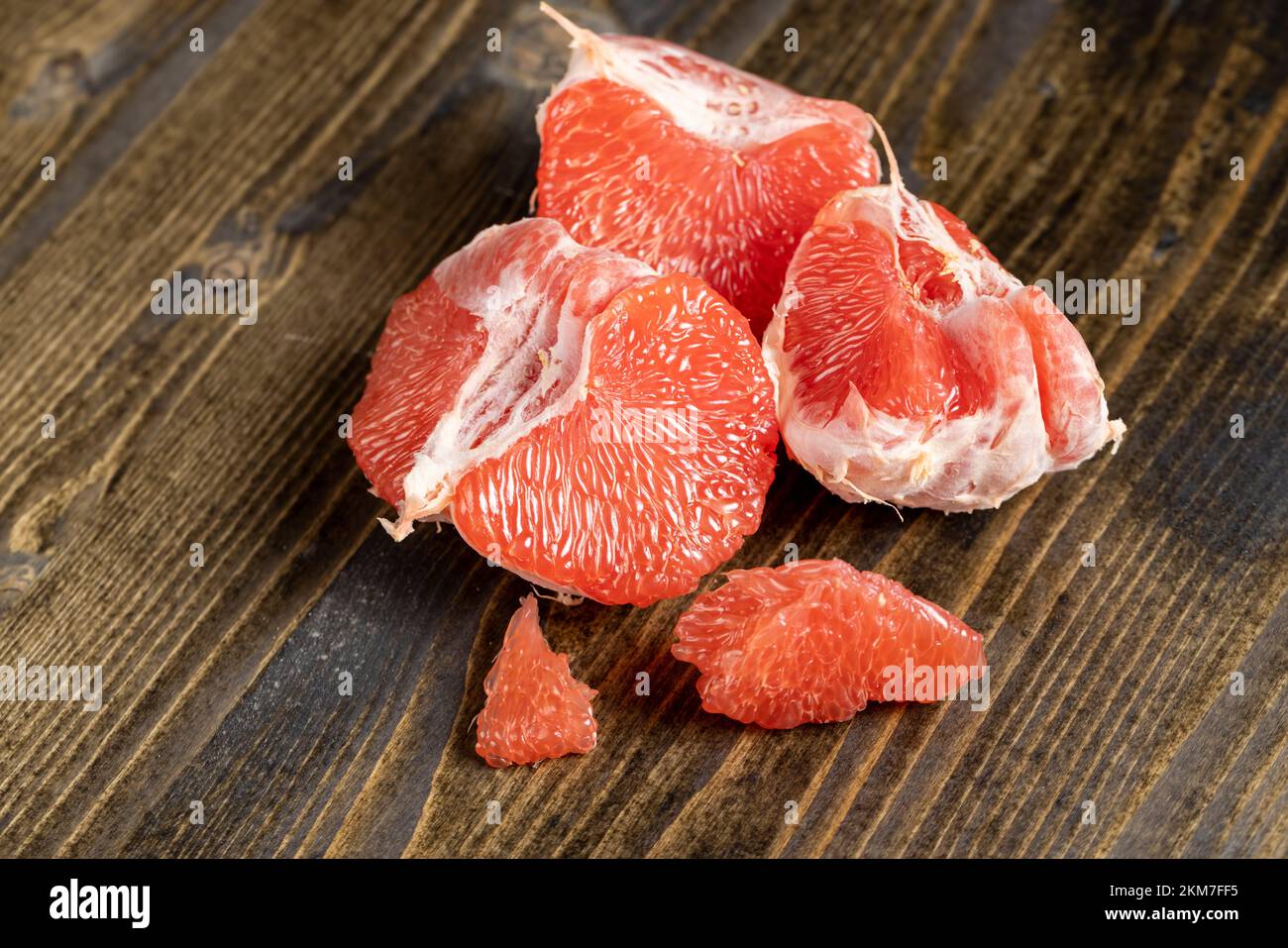 red ripe grapefruit on a cutting board, peeled to pulp ripe red ...