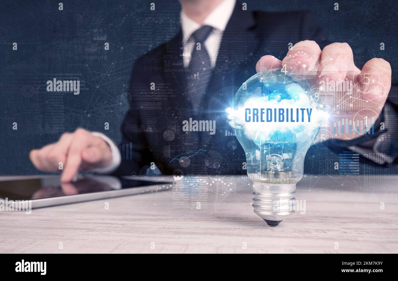 Businessman holding a light bulb, business concept Stock Photo - Alamy