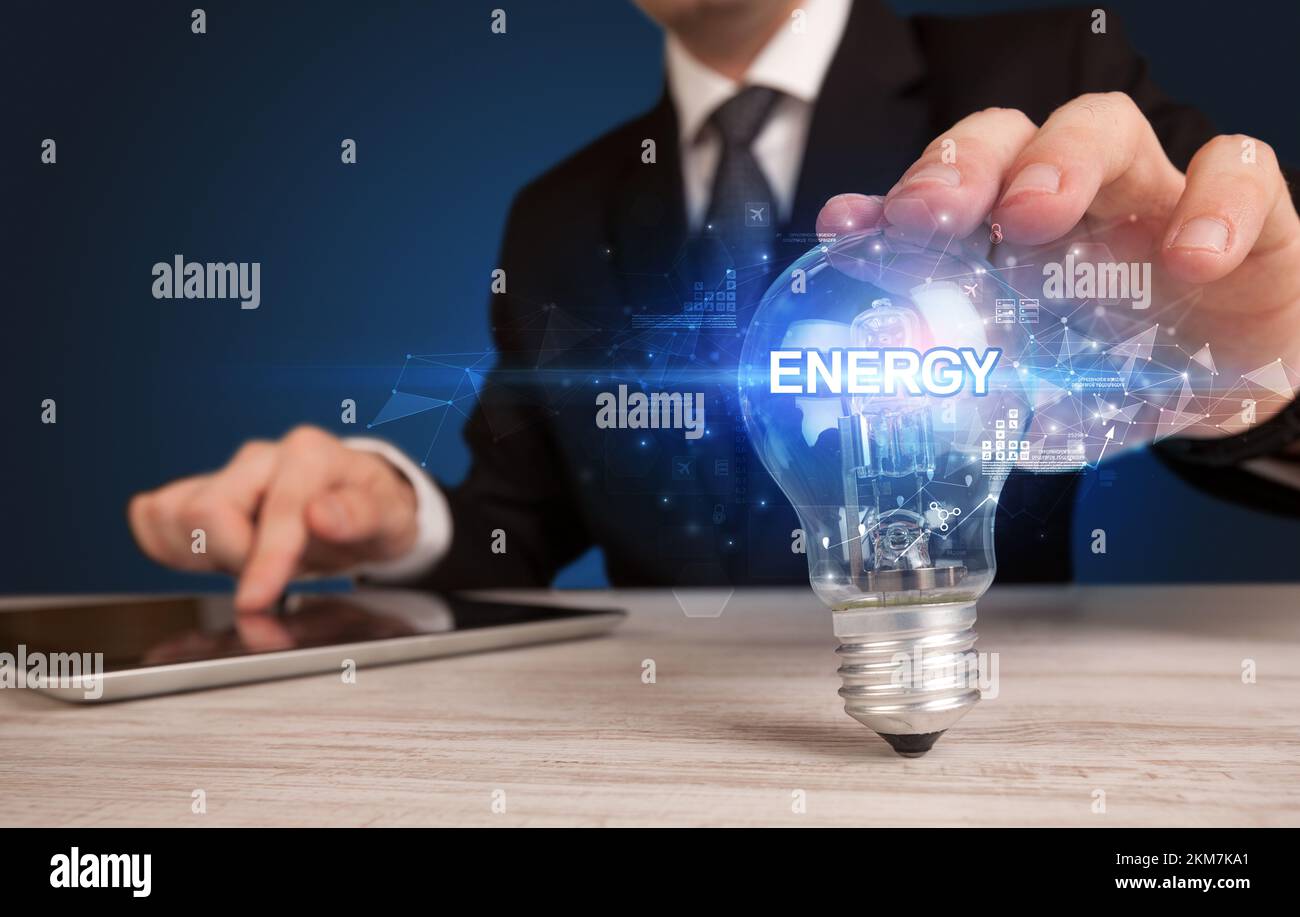 Businessman holding a light bulb Stock Photo - Alamy
