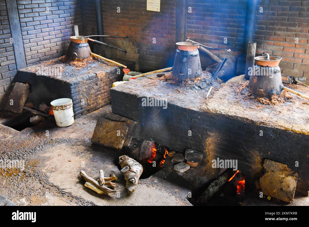 The distillation process of the fermented maguey in a artisanal Mezcal ...