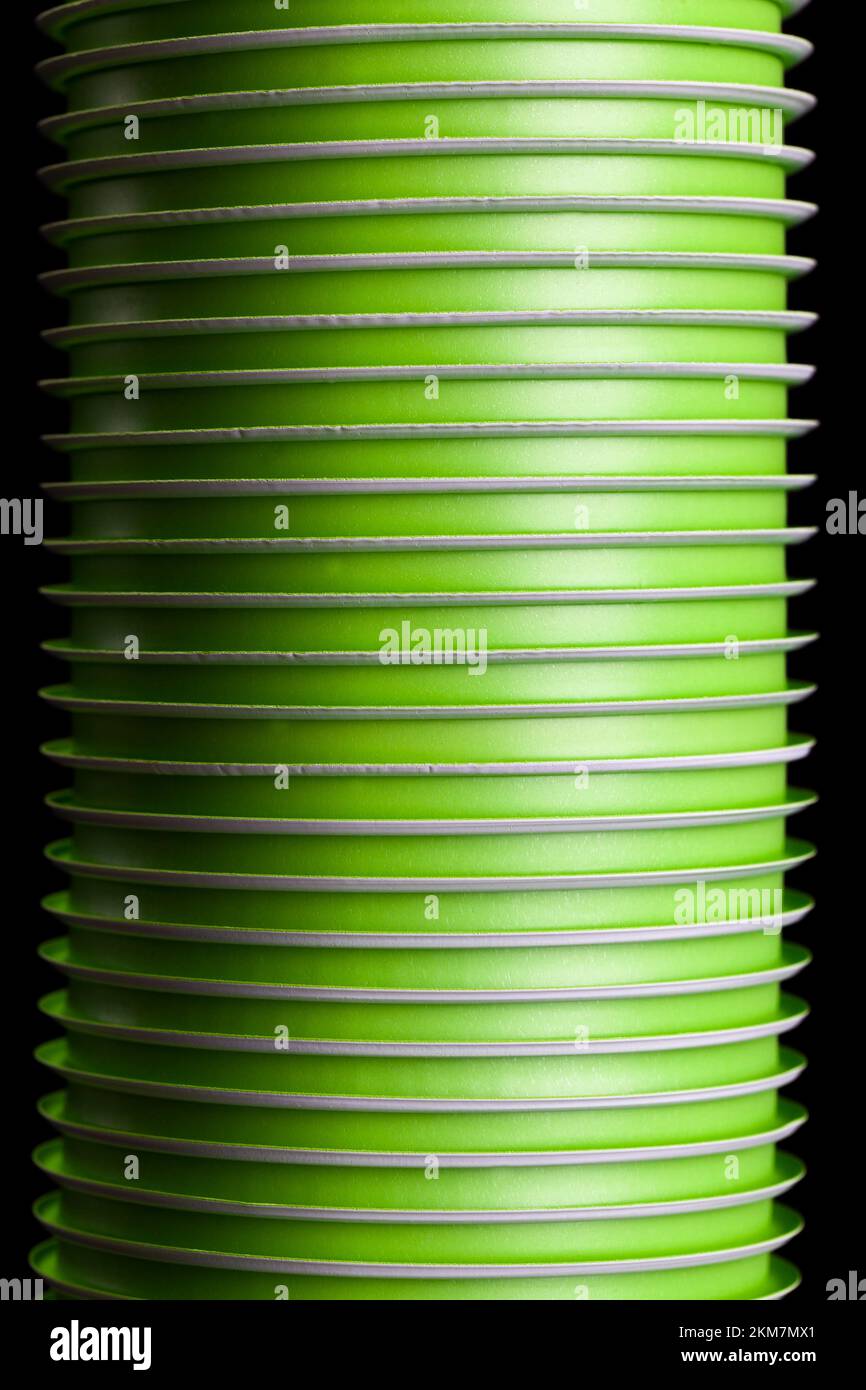 disposable plastic cups of green color, a group of clean new plastic ...