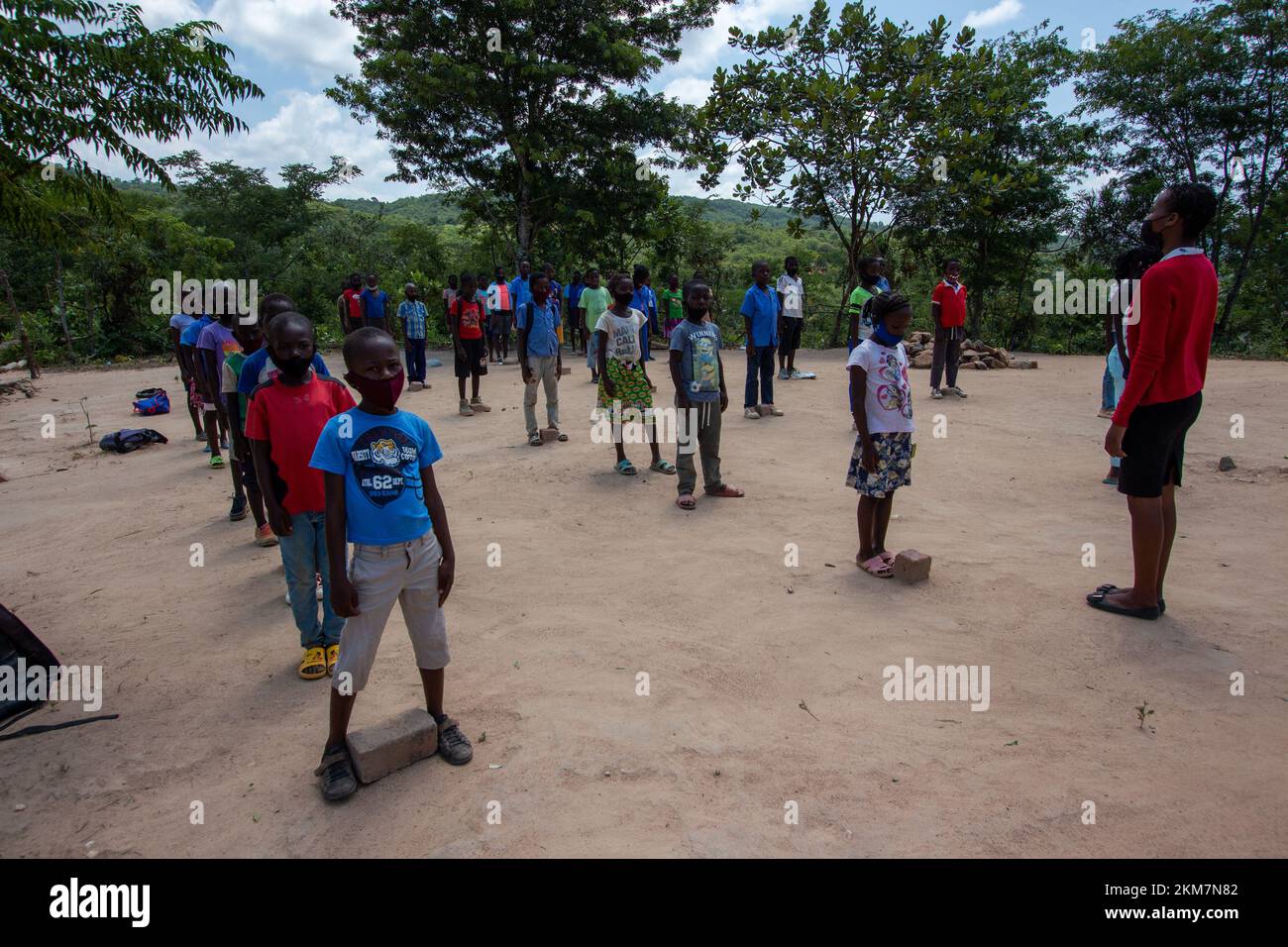 Primary students lining up to sing the national anthem in the school ...