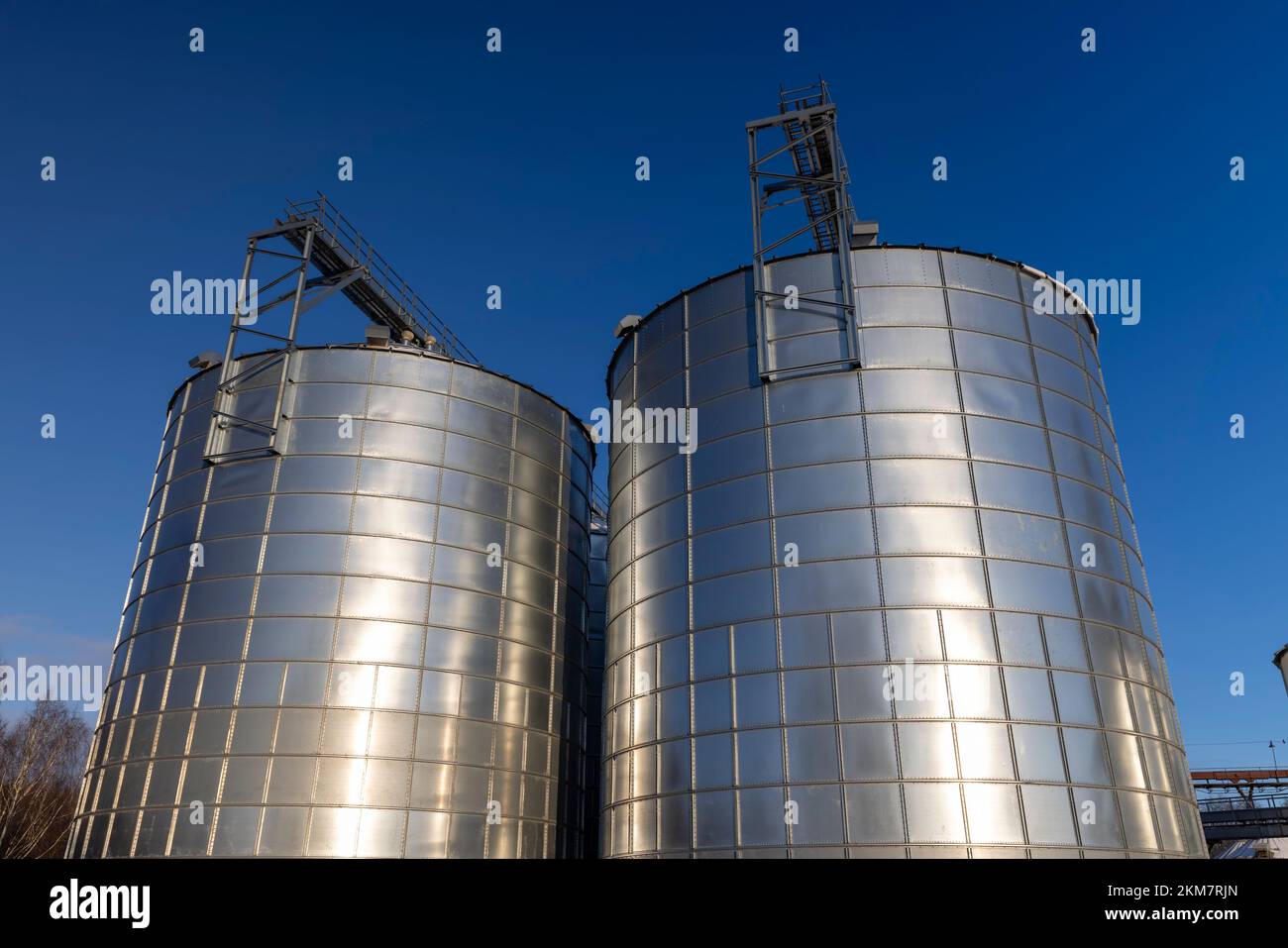 modern metal silo of large size, a silo at an agricultural enterprise ...