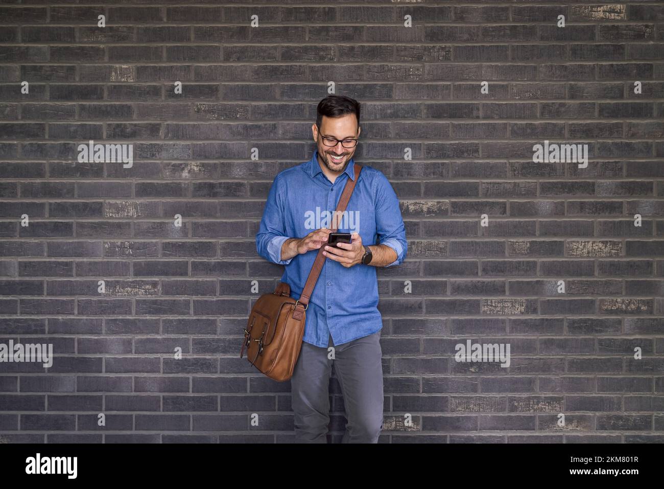 Man outside building checking hi-res stock photography and images - Alamy