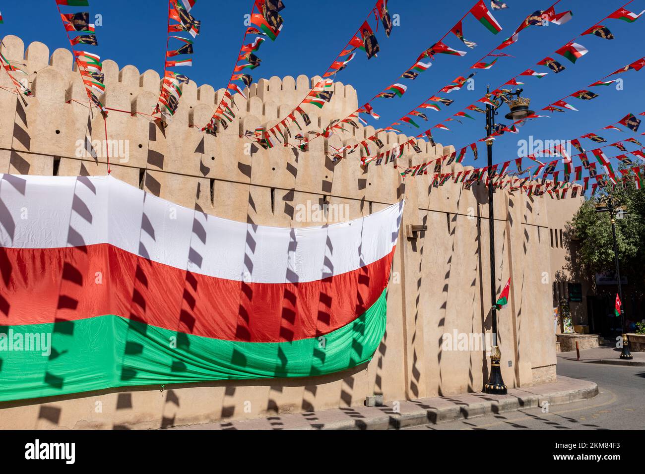 Oman national flag during Independence Day. Traditional medieval ...