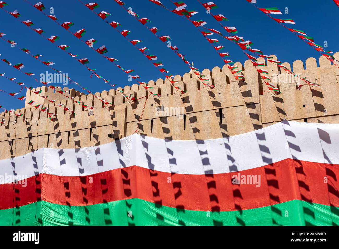 Oman national flag during Independence Day. Traditional medieval ...