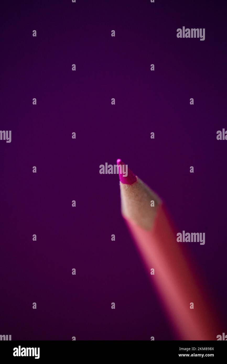 Pink colouring crayon pencil isolated on dark purple background Stock ...