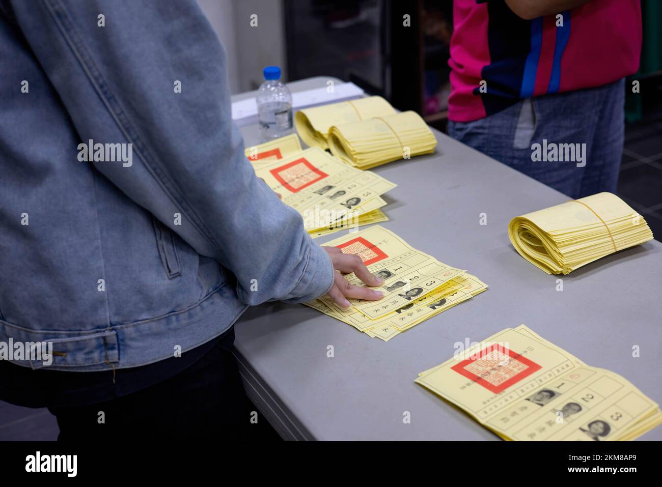 A close-up of polling official counting votes at Rinari polling station ...