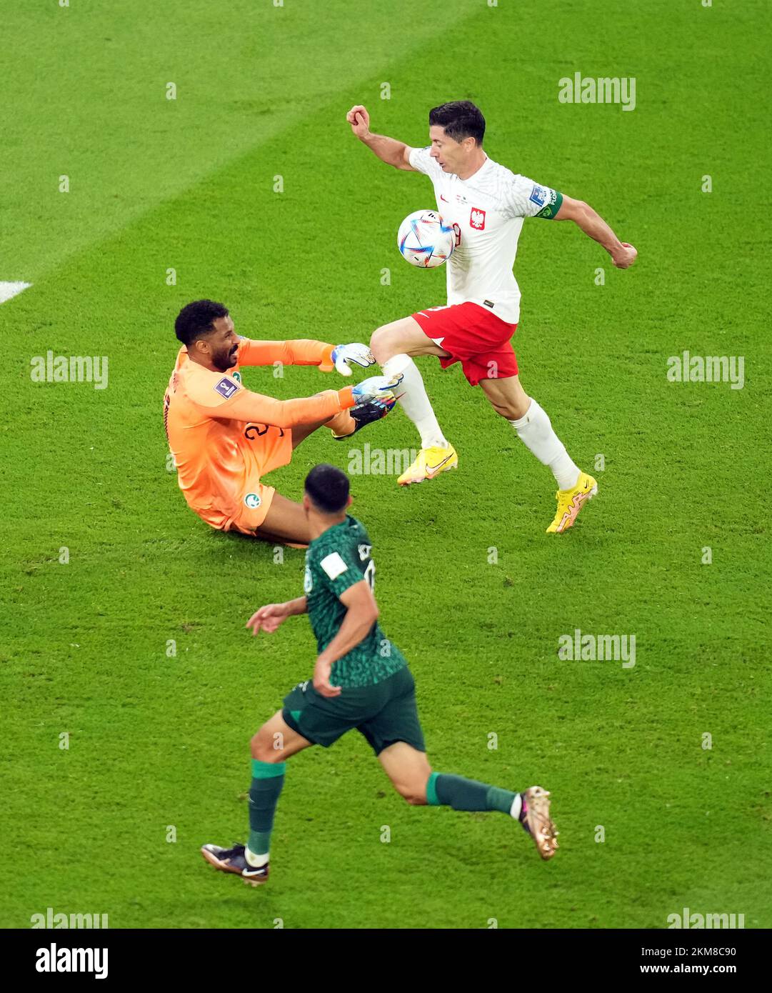 Saudi Arabia goalkeeper Mohammed Al-Owais saves from Poland’s Robert ...
