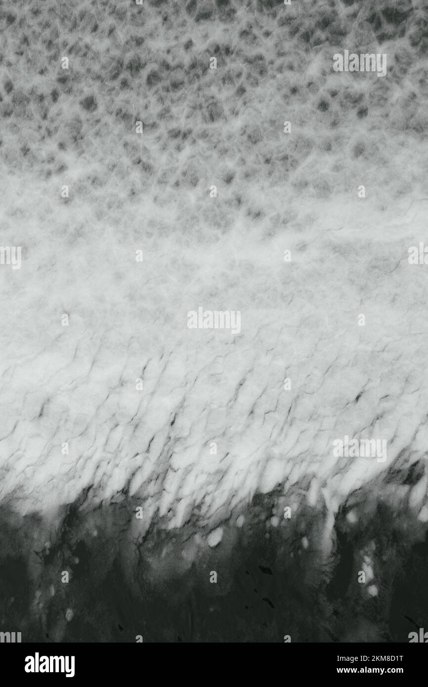 A textured image of sea ice forming on the southern ocean, with a black ...