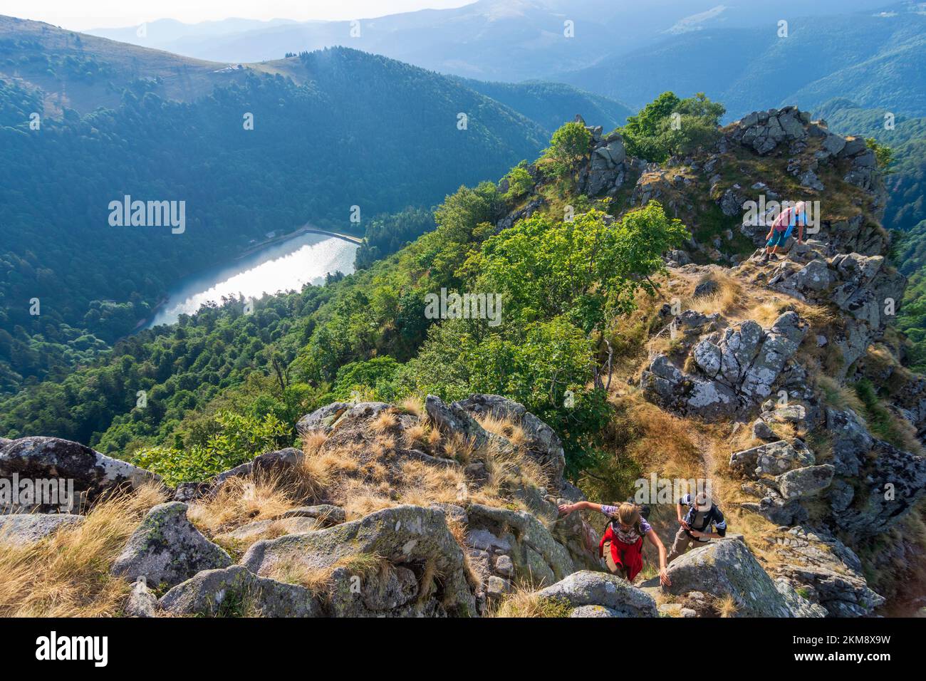 Vosges (Vogesen) Mountains: rocks Spitzkoepfe at summit Hohneck, hiker ...