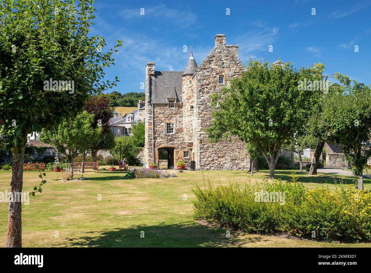 The House of Mary Stuart made of bricks with a green garden and lush ...