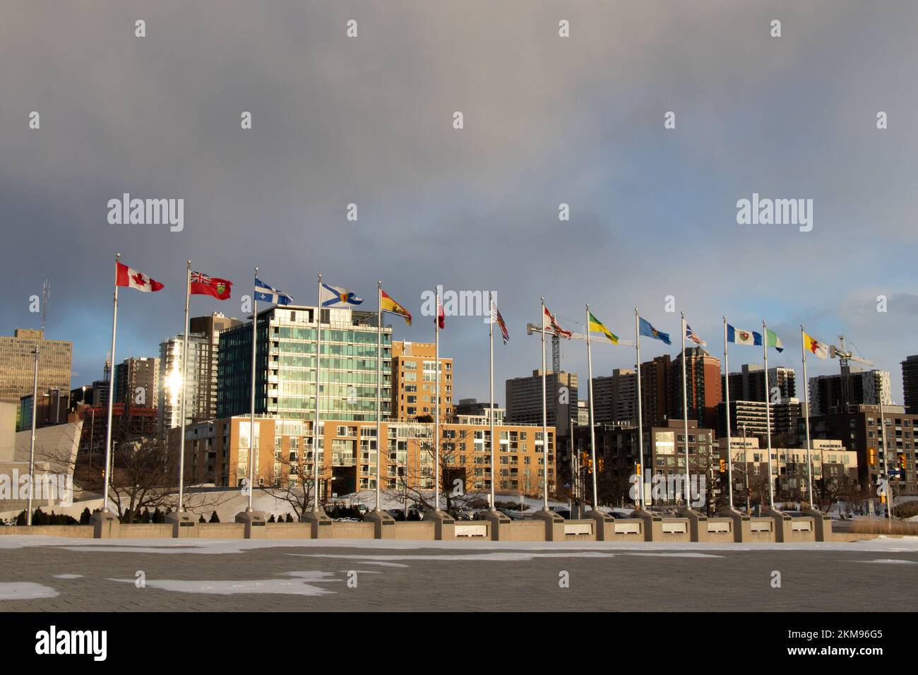 The Flag of Canada and all 13 Provinces and Territories are seen out front of the Canadian War ...