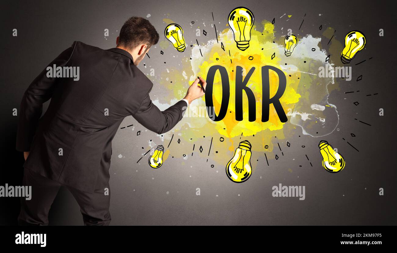 man drawing colorful light bulb Stock Photo - Alamy