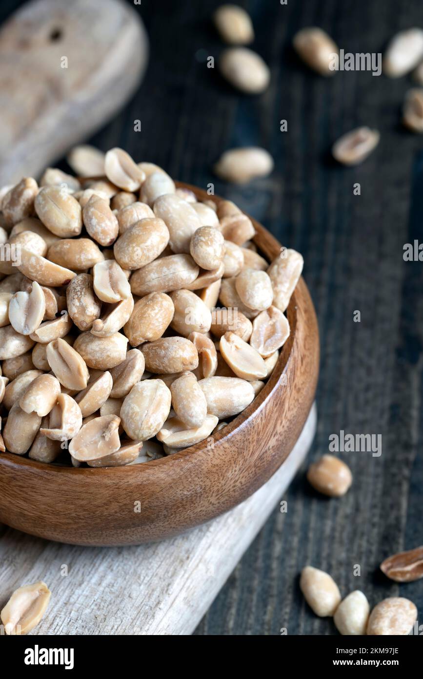 roasted peanuts peeled from the shell on a wooden table, peanuts fried ...