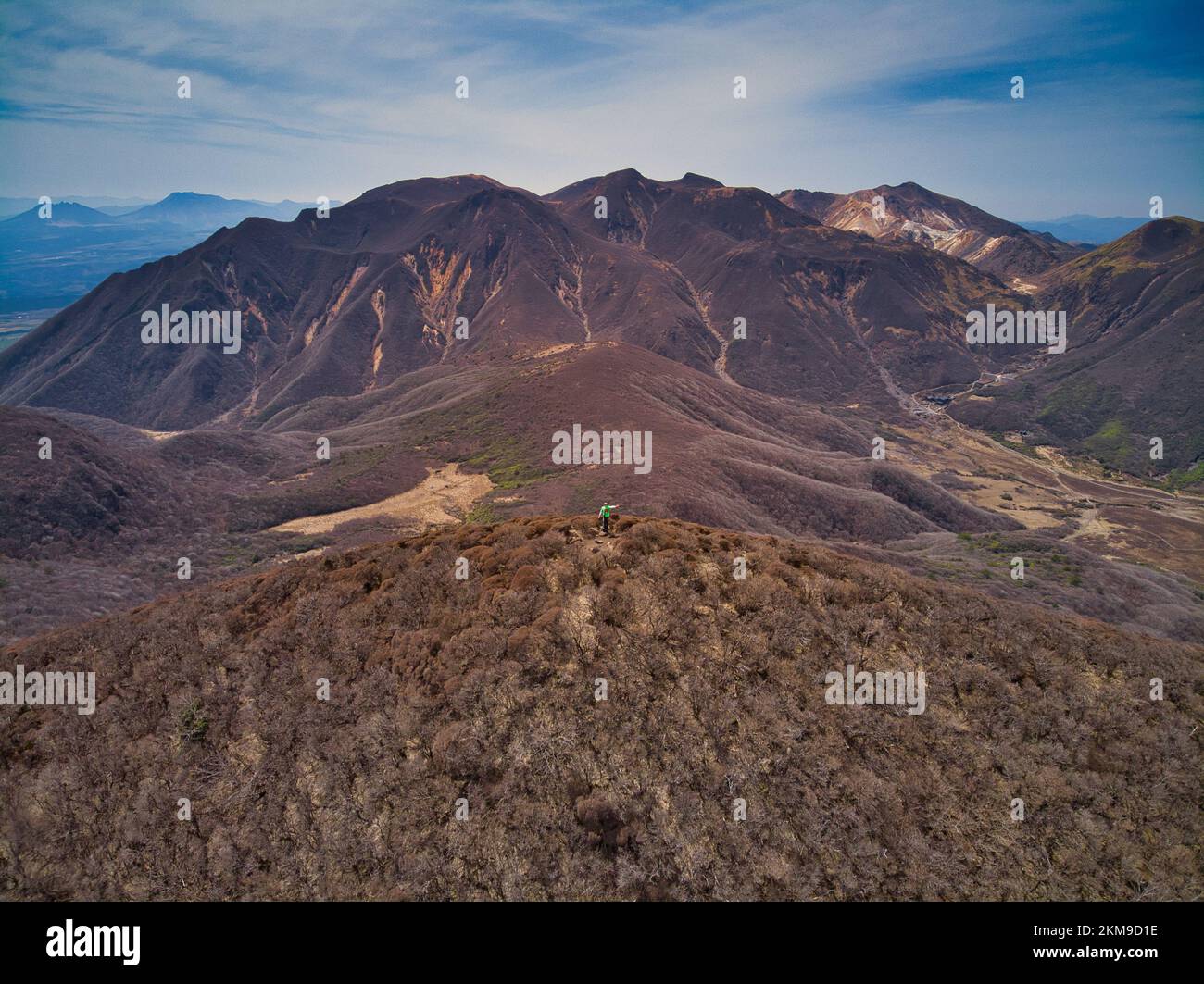 The aerial view of Kuju mountains against the background of blue sky ...