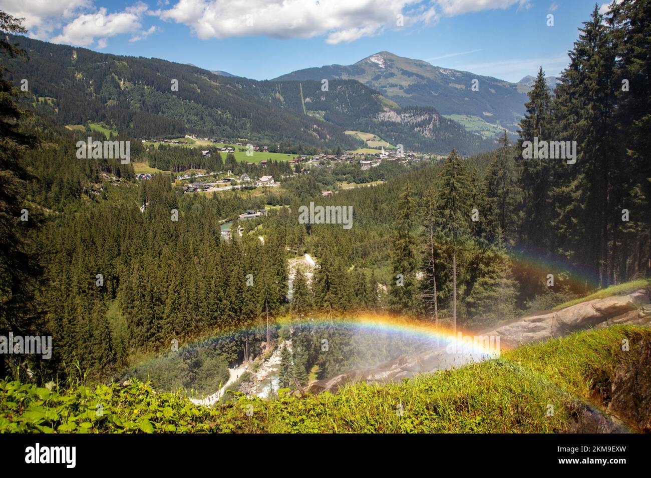 A mesmerizing landscape of a rainbow over the green hills Stock Photo ...