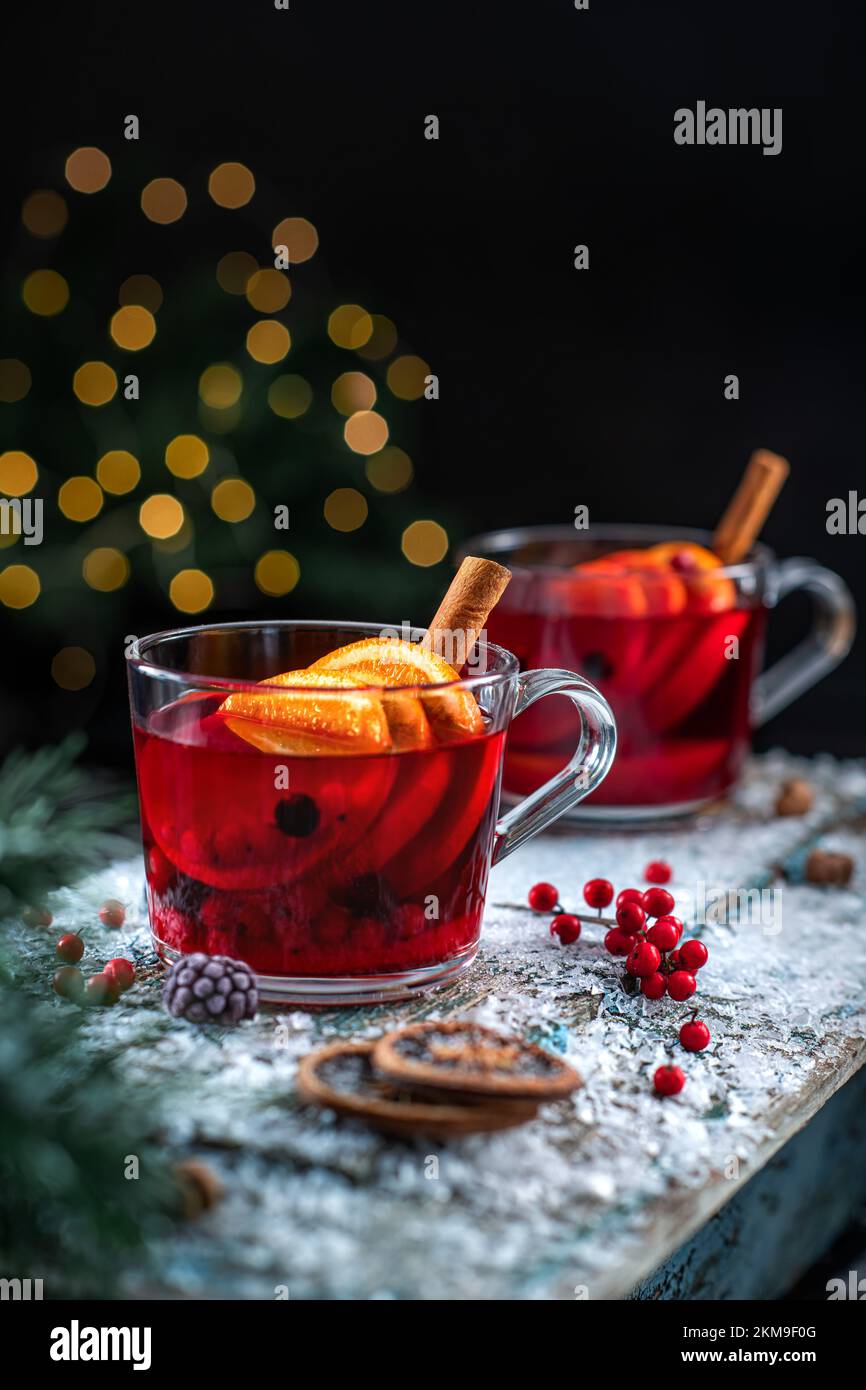 Mulled wine, hot punch or berry tea with slices of orange and cinnamon ...