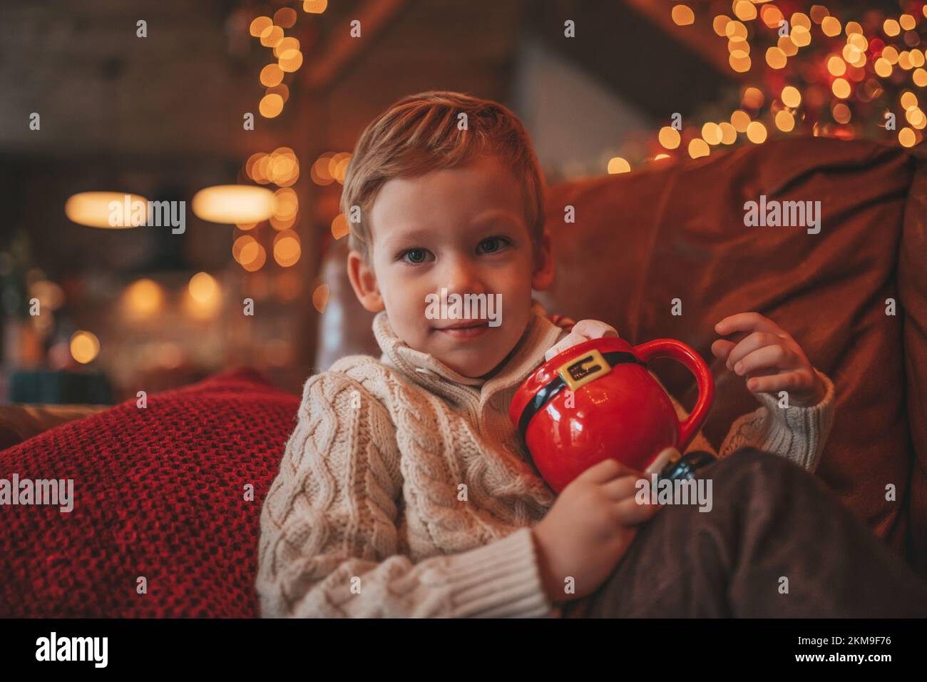 Happy little boy dreamer waiting at miracle Santa enjoy sweets color ...