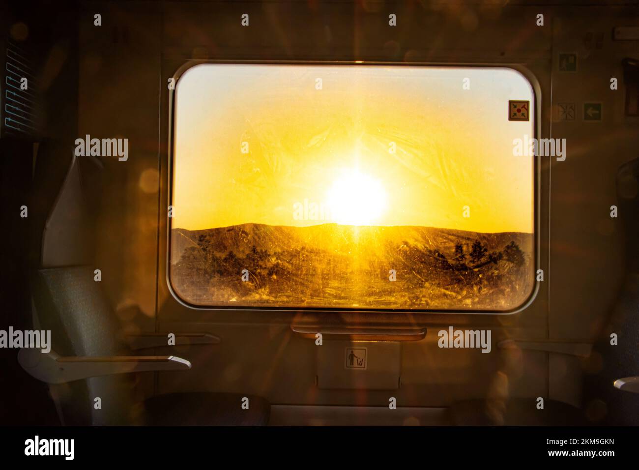 Interior of a passenger train with a view from the window of the sun ...