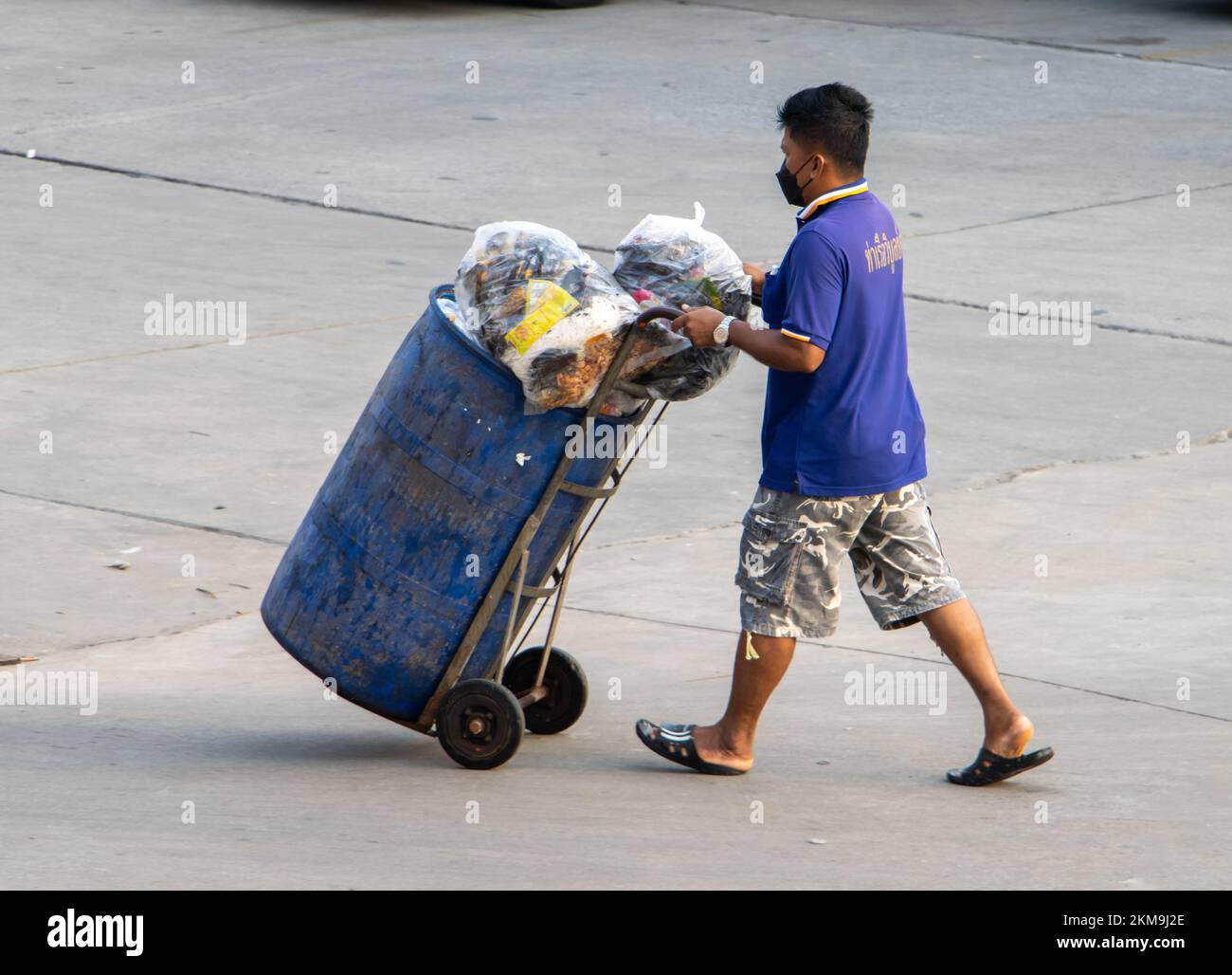 SAMUT PRAKAN, THAILAND, MARCH 02 2022, Worker push a cart with the full ...