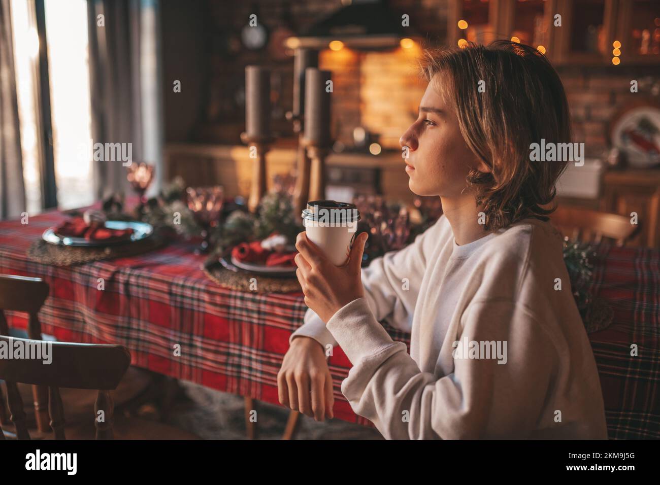 Young teen boy with long hair thoughtful look sad eyes negative mood ...