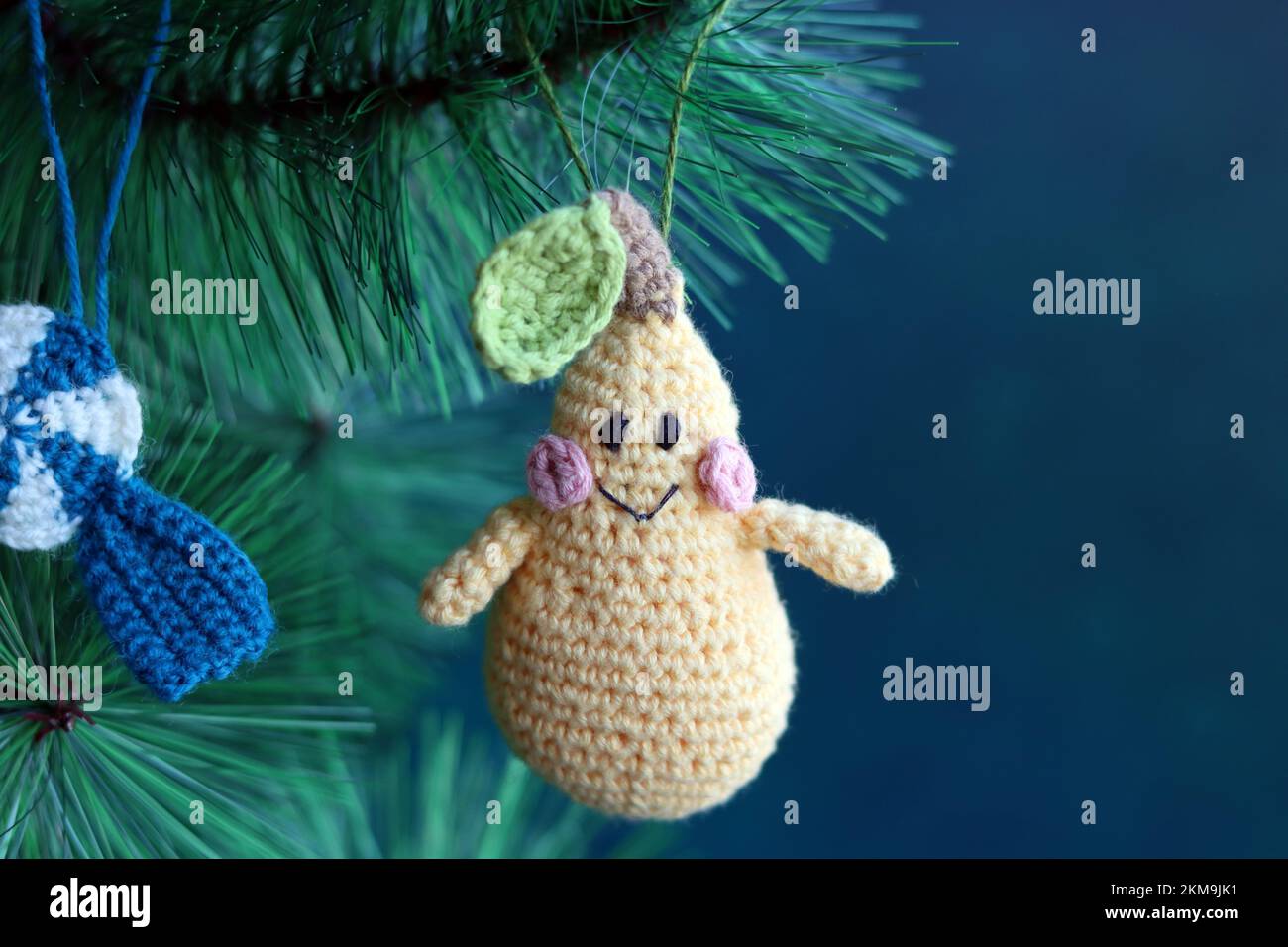 Hand made Christmas toys on a tree. Cute crochet decorations close up ...