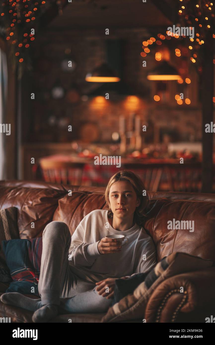 Young teen boy with long hair thoughtful look sad eyes negative mood ...