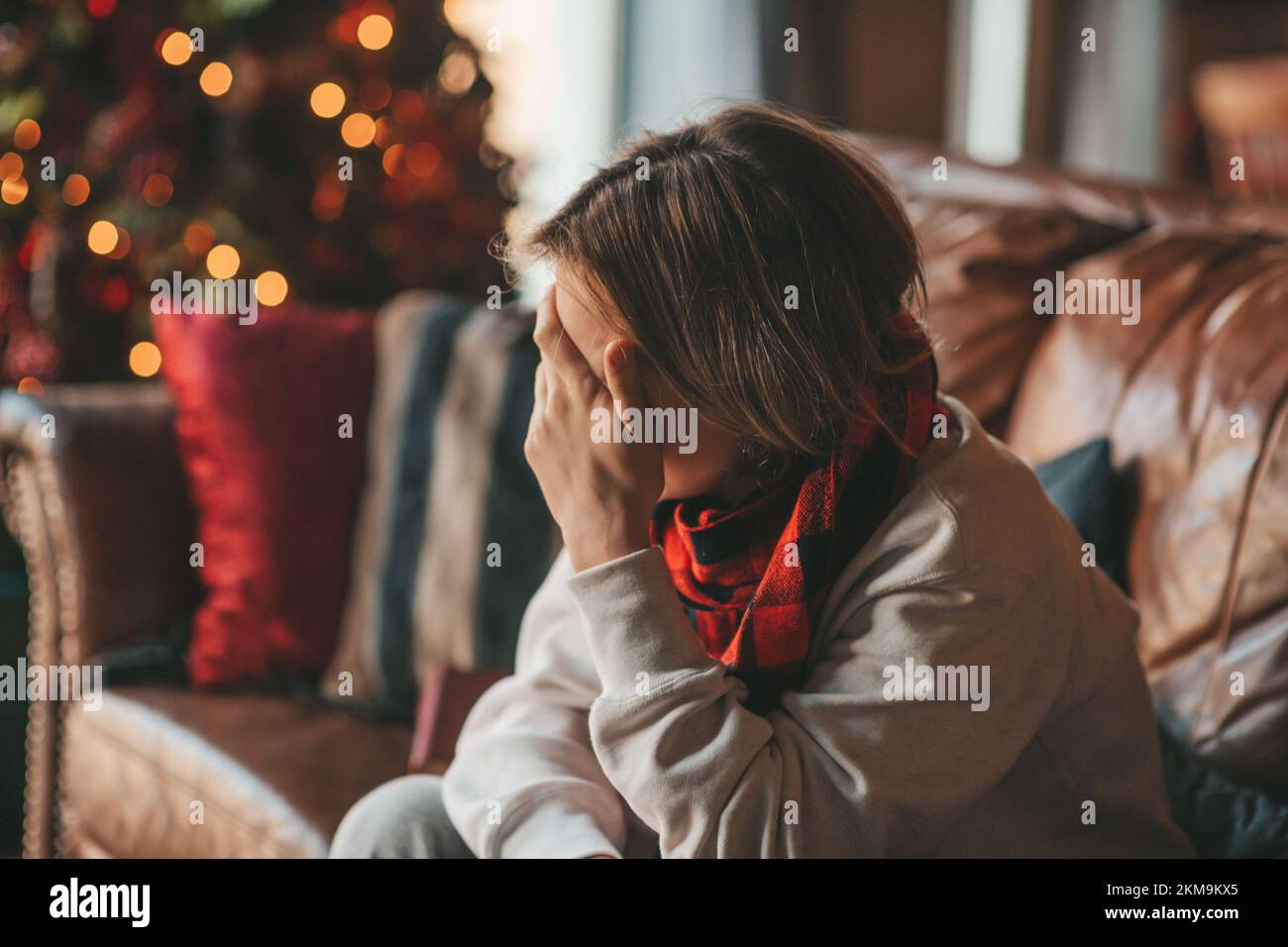 Young teen boy with long hair thoughtful look sad eyes negative mood ...