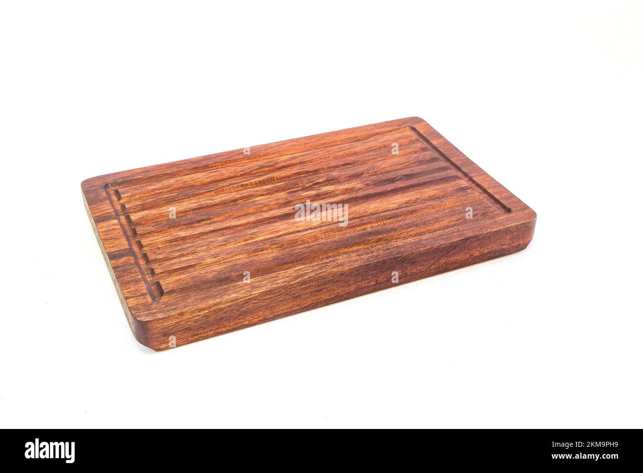 A closeup of a natural wooden cutting board isolated on the white ...