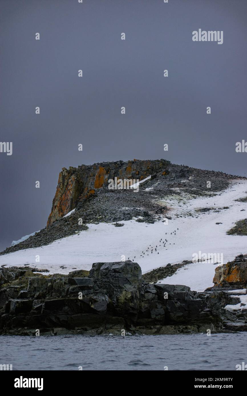 Rocky Formation on Deception Island, with flat top rock, snow, and ...